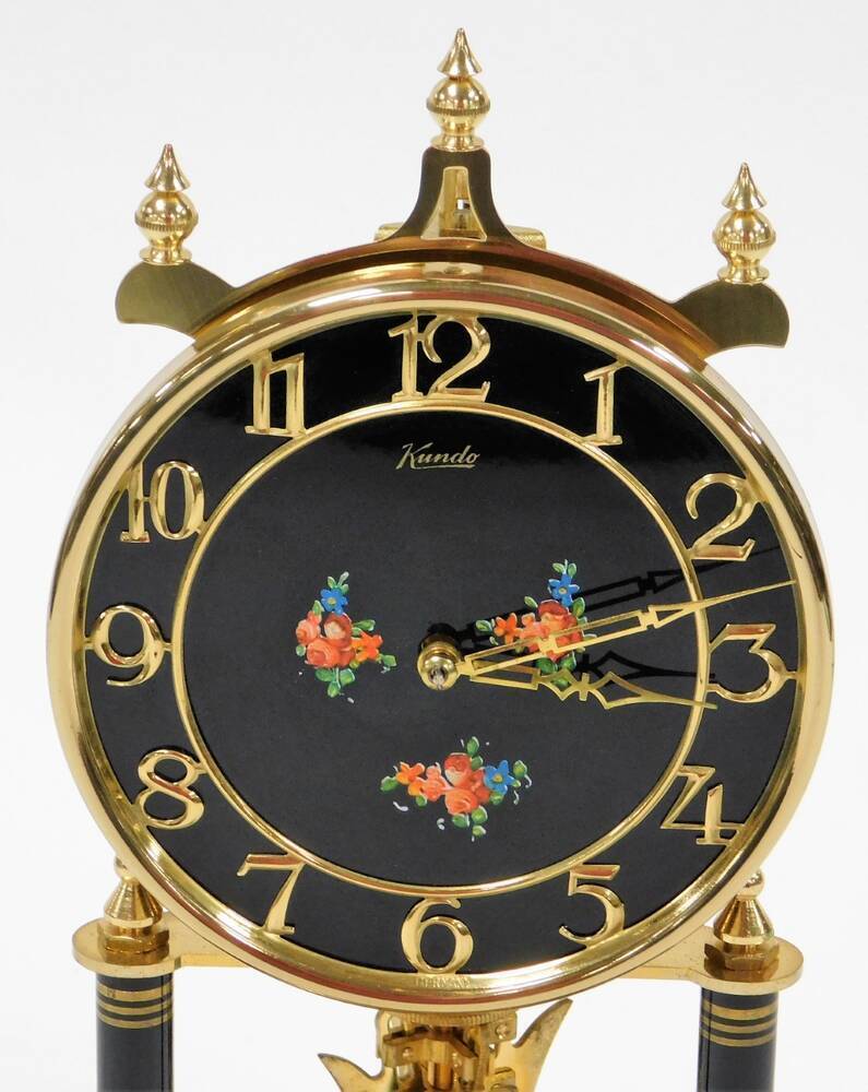 A Kundo glass domed mantel clock, the black coloured face with rose and ...