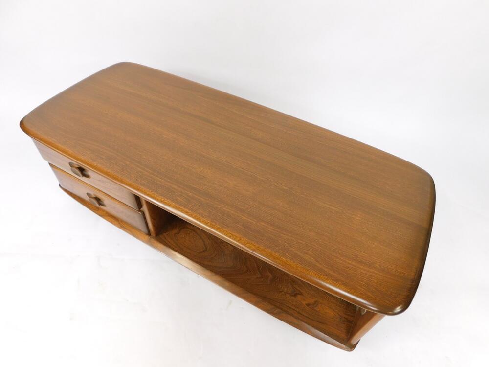 An Ercol dark elm Minerva 844 two drawer coffee table, raised on ...