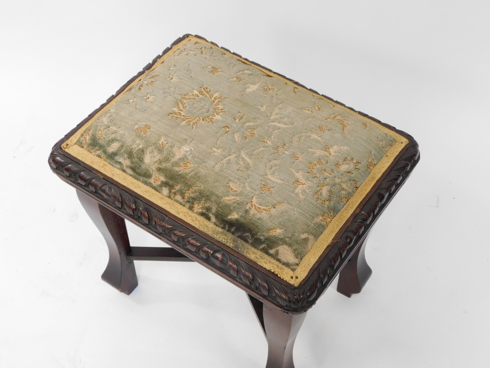 A late Victorian oak stool, of oblong form, with heavily carved ...