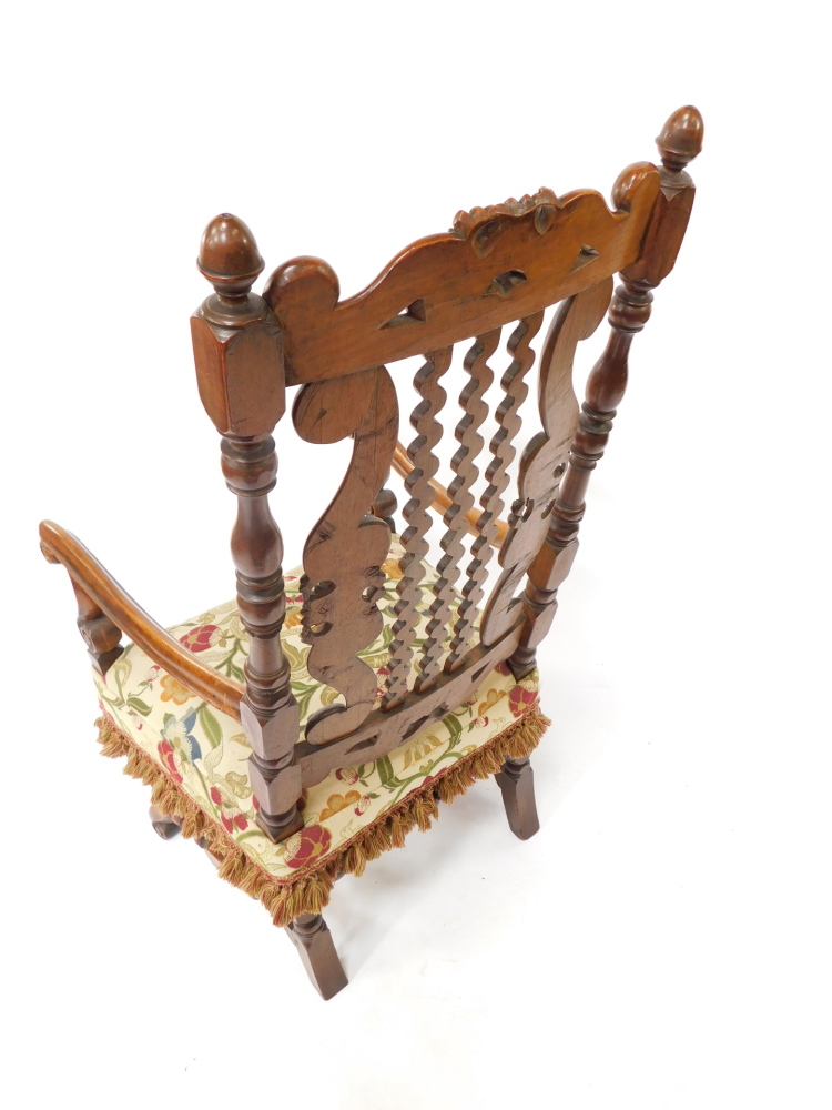 A 19thC heavily carved walnut throne type armchair, with a pierced ...