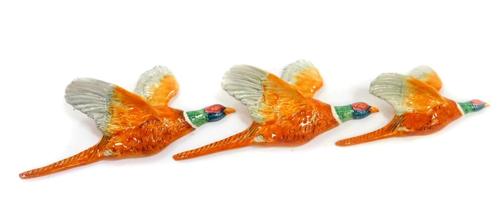 A set of three Beswick pottery graduated wall plaques modeled as ...