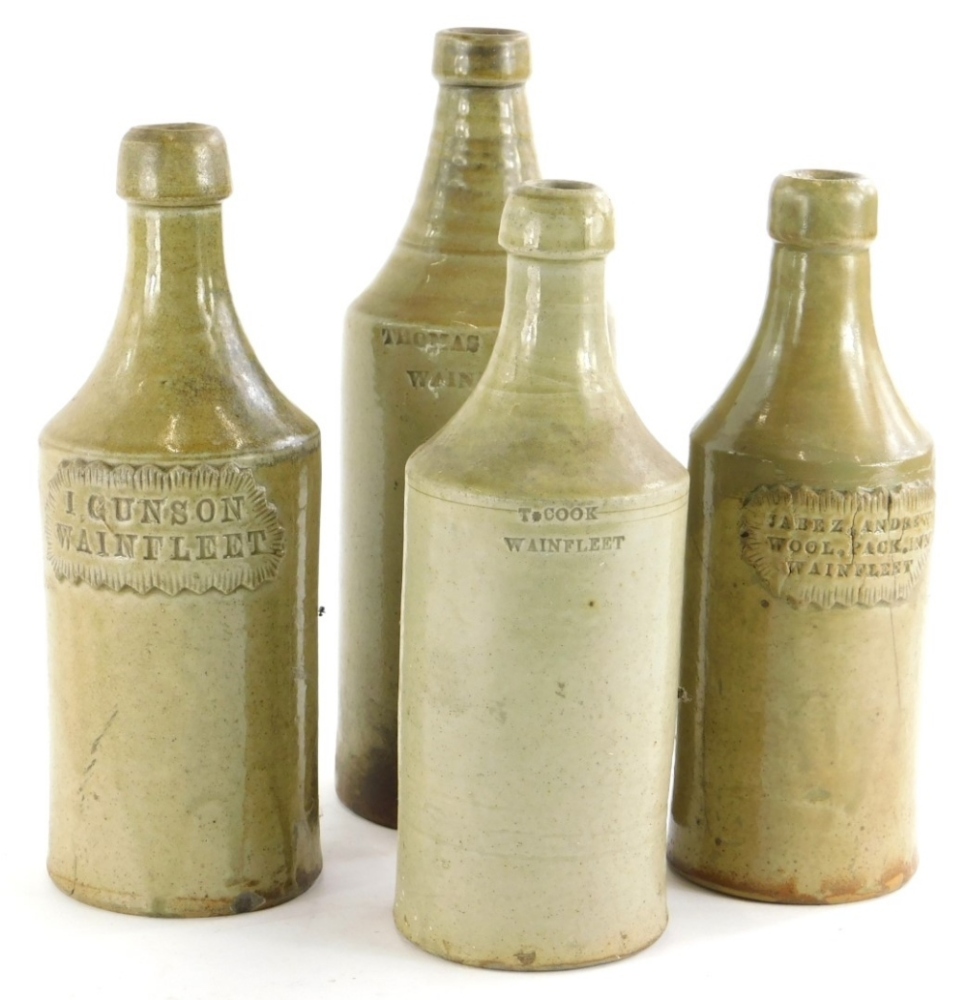 A collection of four slab seal stoneware porter bottles, to include ...
