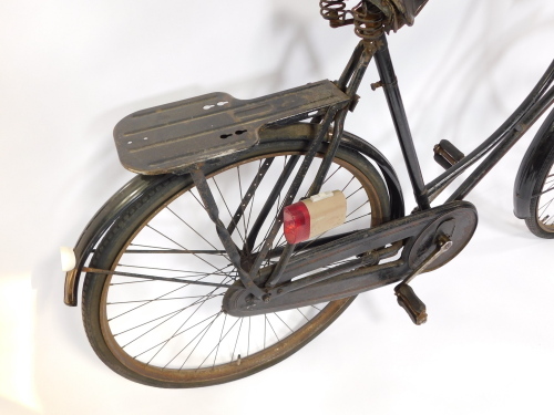 A vintage Raleigh black loop frame bicycle, c1930's, with red trim and ...