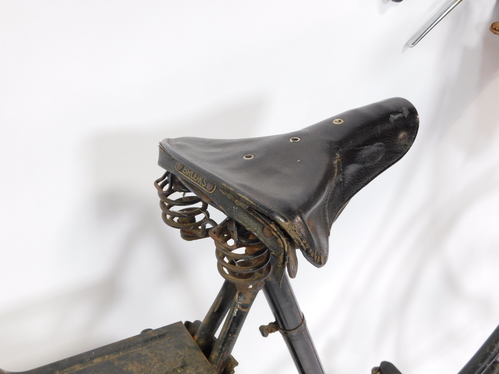 A vintage Raleigh black loop frame bicycle, c1930's, with red trim and ...