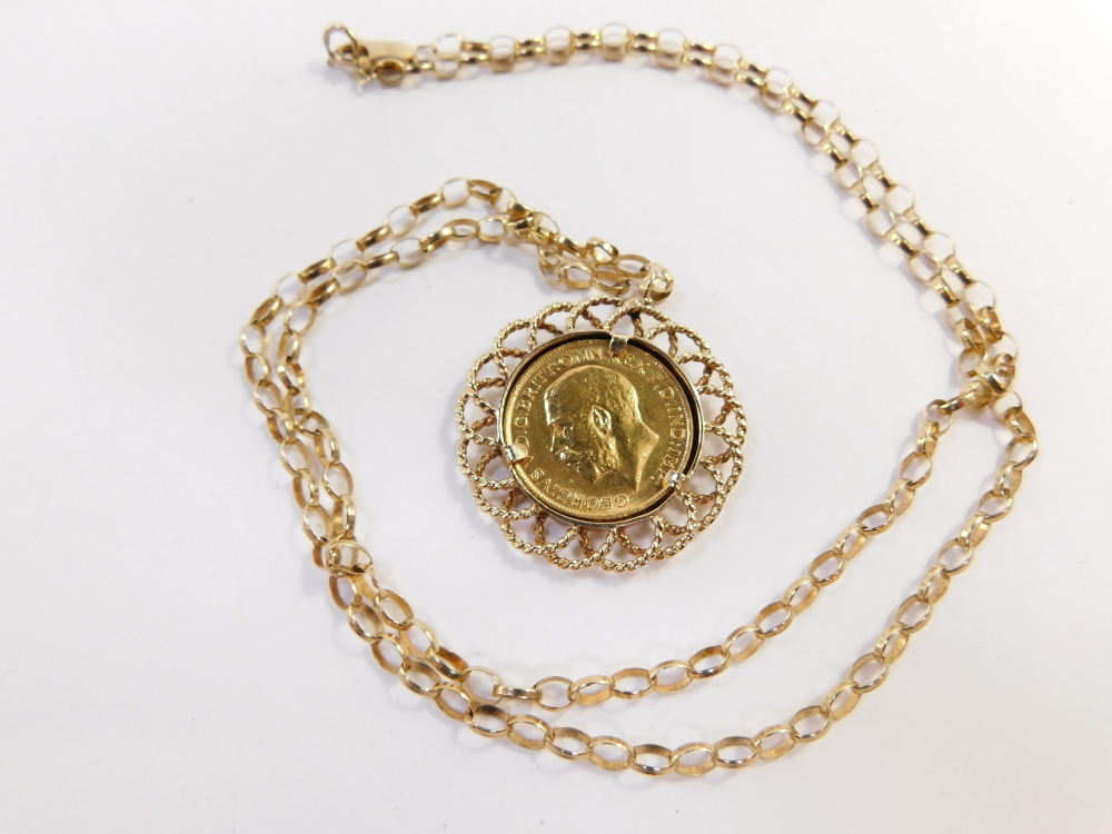 A George V full gold sovereign pendant and chain, dated 1913, in a ...
