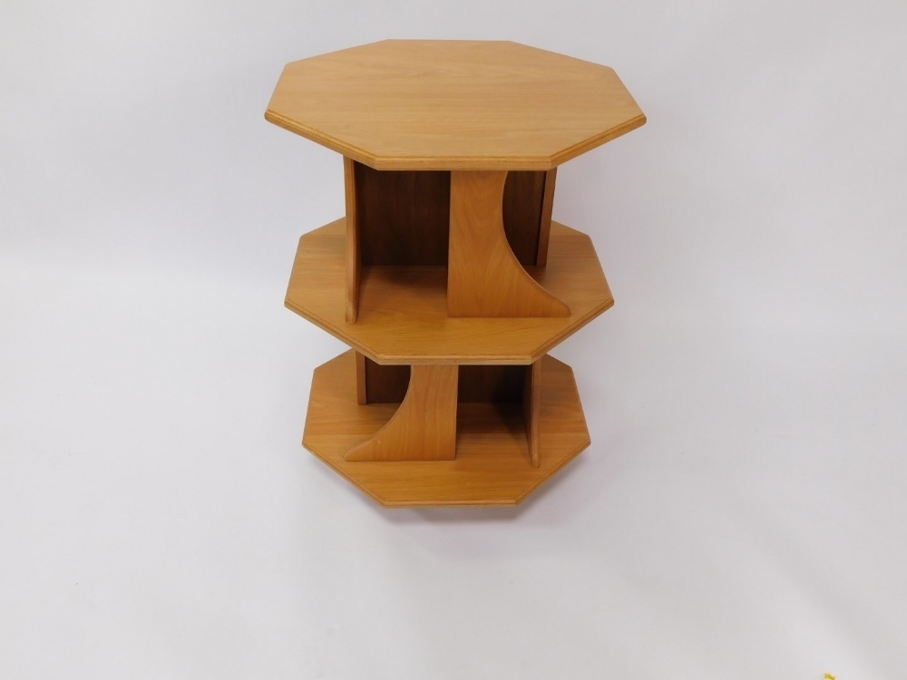 A 20thC light wood rotating bookcase, of octagonal form on a rotating ...