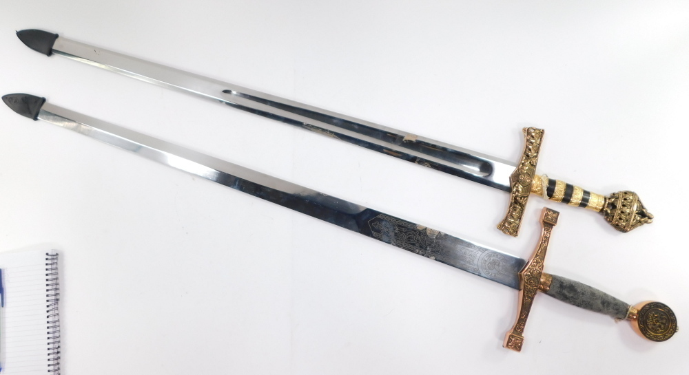 Two replica swords, one stamped King Arthur Excalibur, each with a gilt ...