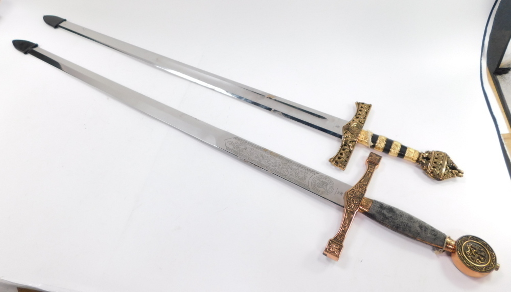 Two replica swords, one stamped King Arthur Excalibur, each with a gilt ...