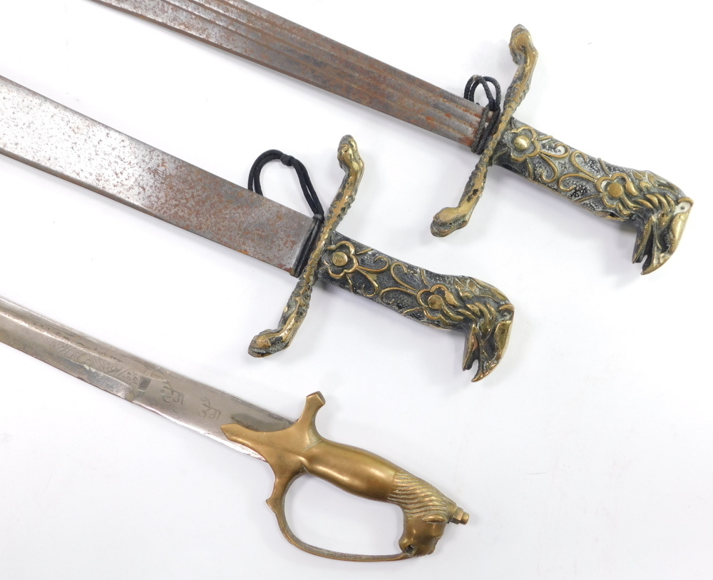 Three Eastern swords, to include a pair of short swords, each with a ...