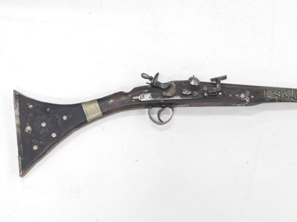 A Middle Eastern replica rifle, with silver coloured metal bands, etc ...