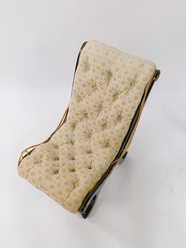 A Victorian ebonised child's X frame chair, with a scroll back, with ...