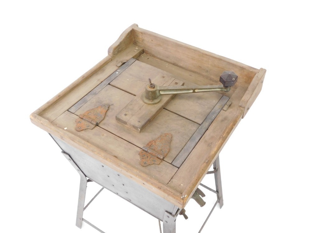 An early 20thC manual washing machine, with wooden frame and turned ...