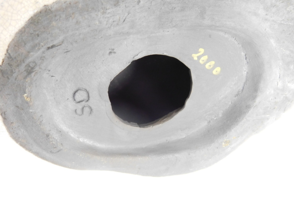 A Raku glazed Studio pottery hare, signed Brian Andrew, in running pose ...