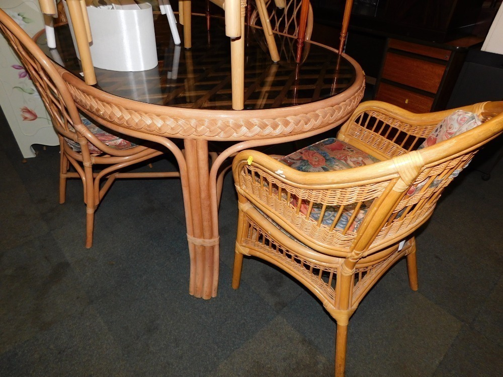 A wicker conservatory table, with glass top, and eight chairs. (9)