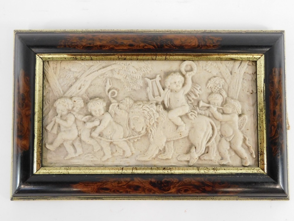 A reconstituted marble plaque depicting cherubs and lion, 29cm x 14.5cm ...