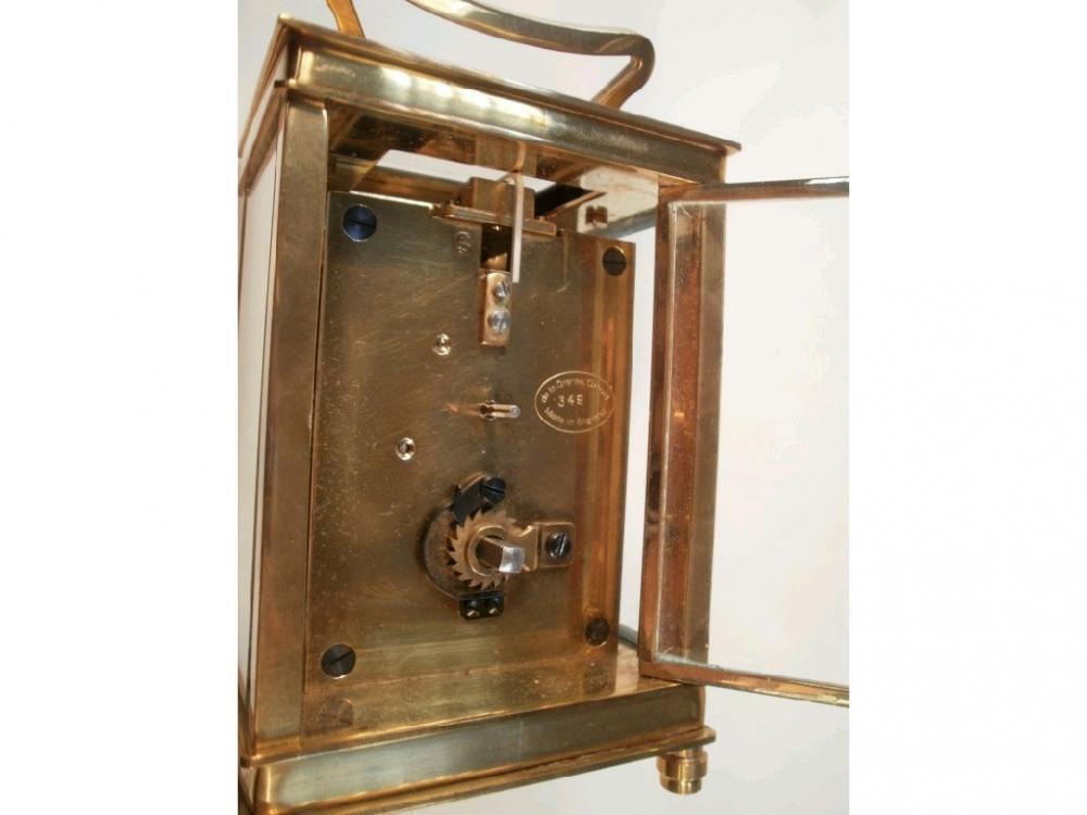 A modern brass carriage clock by De La Grense with plain enamelled dial