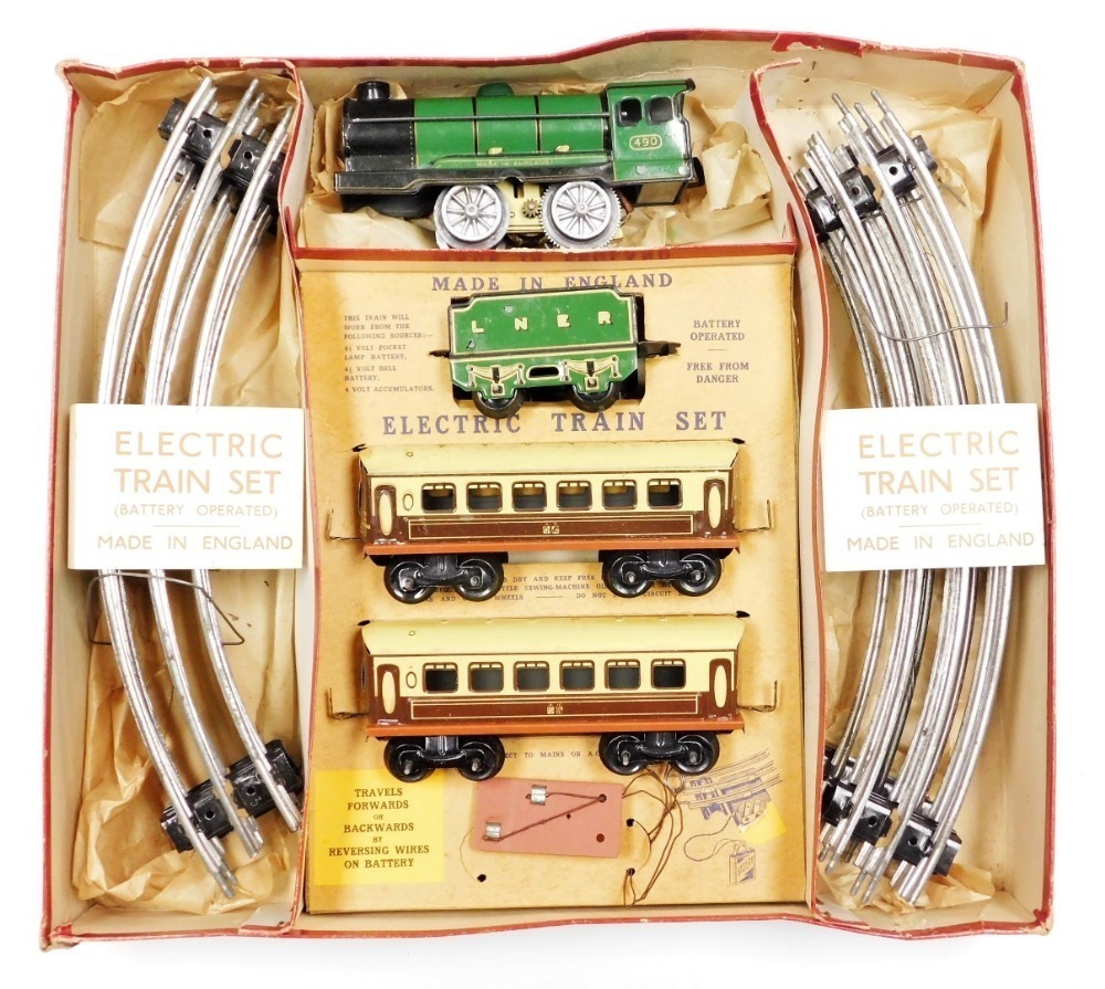 A tin plate battery operated reversing electric O gauge train set, the ...