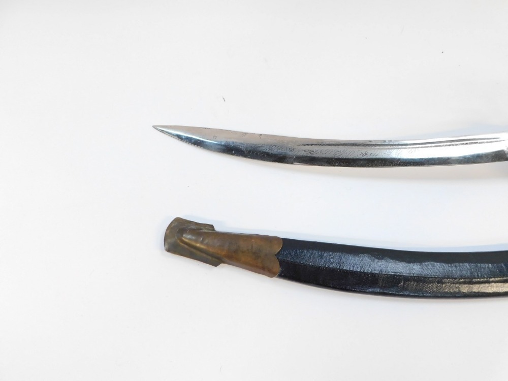 An Indian short sword, with engraved blade, and wire bound leather grip ...