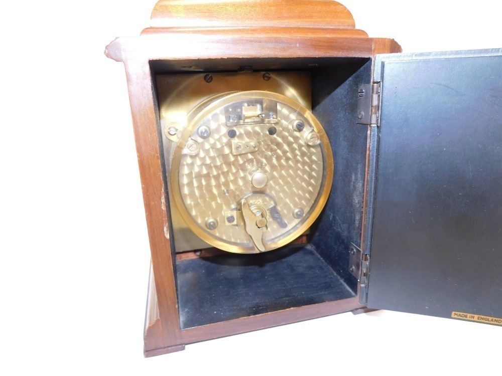 A walnut cased Rotherham's mantel clock, the carved three point top ...