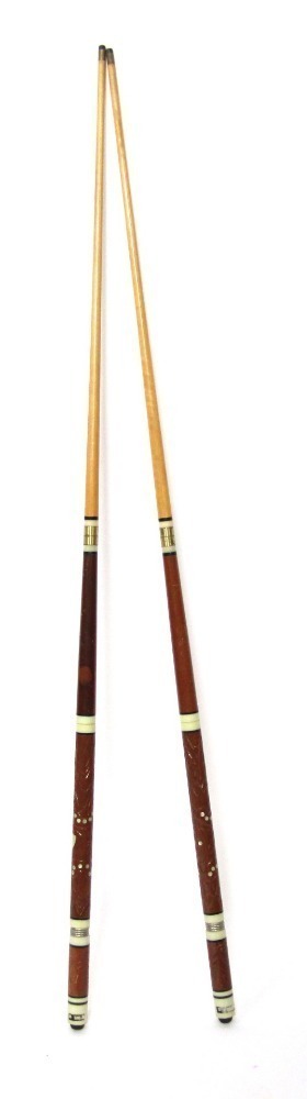 Two carved snooker cues, each with mother of pearl inlay, brass cap ...