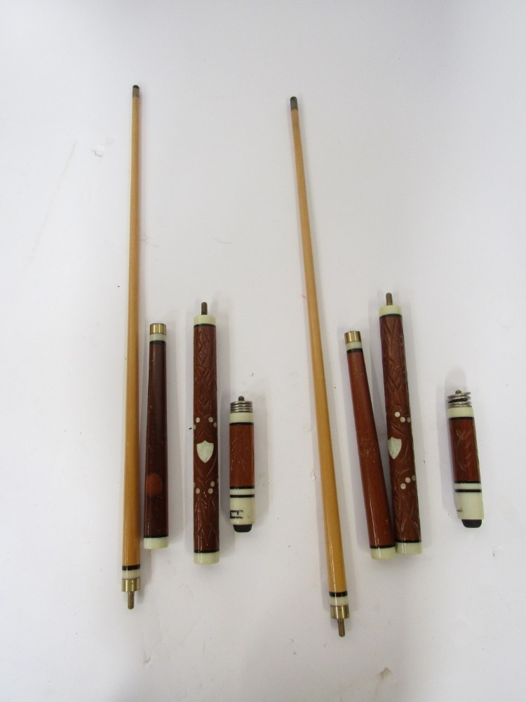 Two carved snooker cues, each with mother of pearl inlay, brass cap ...