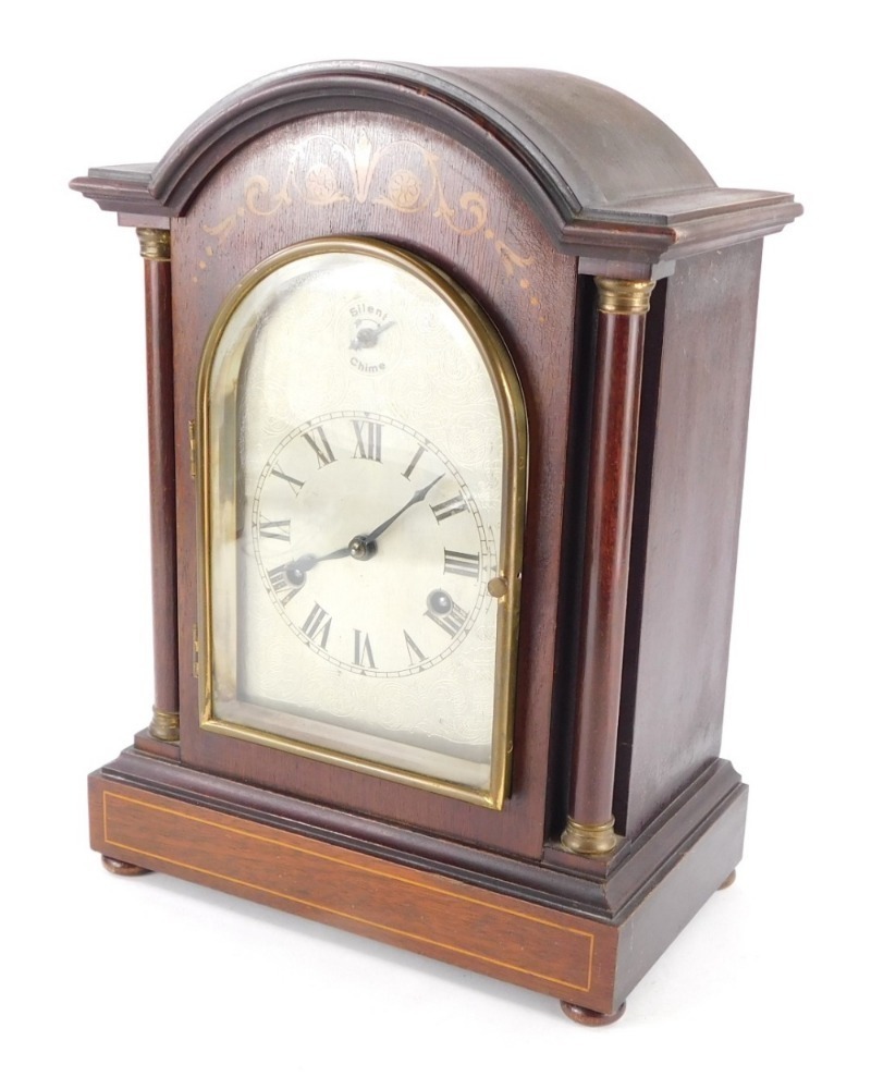 An Edwardian mahogany table clock, in arched case, the 12cm wide ...