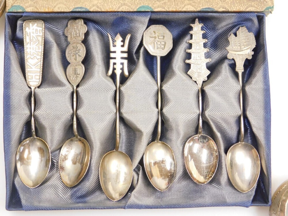 A set of six Chinese white metal teaspoons, each handle cast with ...