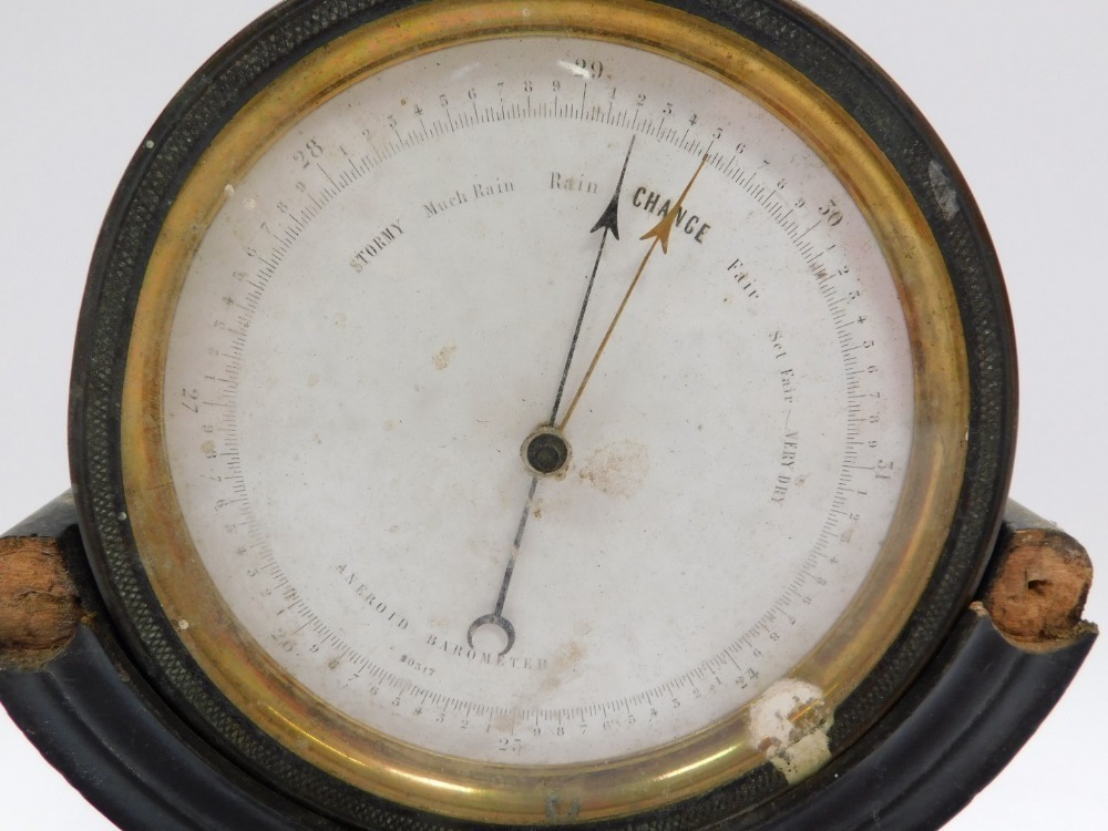 A 19thC aneroid barometer, the white enamel casing in a metal surround ...