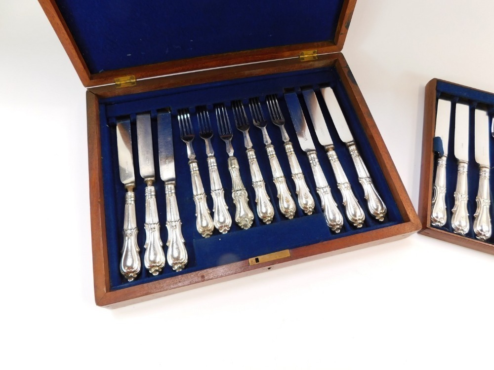 A cased set of twelve silver plated knives and forks, each with a ...