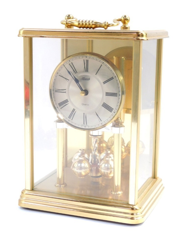 A Hermle brass cased Anniversary clock, the silvered dial with Roman ...