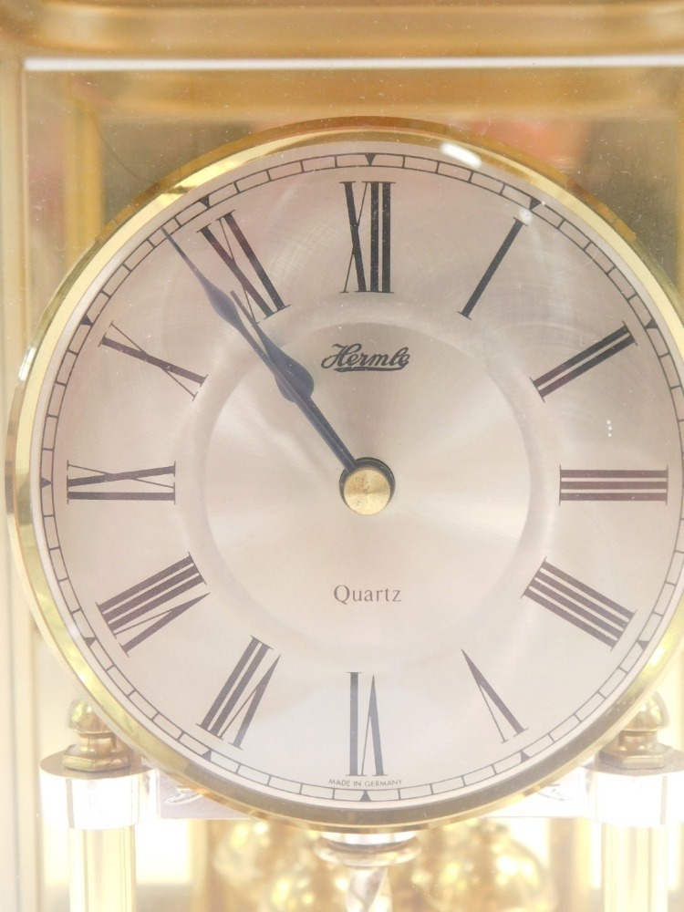 A Hermle brass cased Anniversary clock, the silvered dial with Roman ...