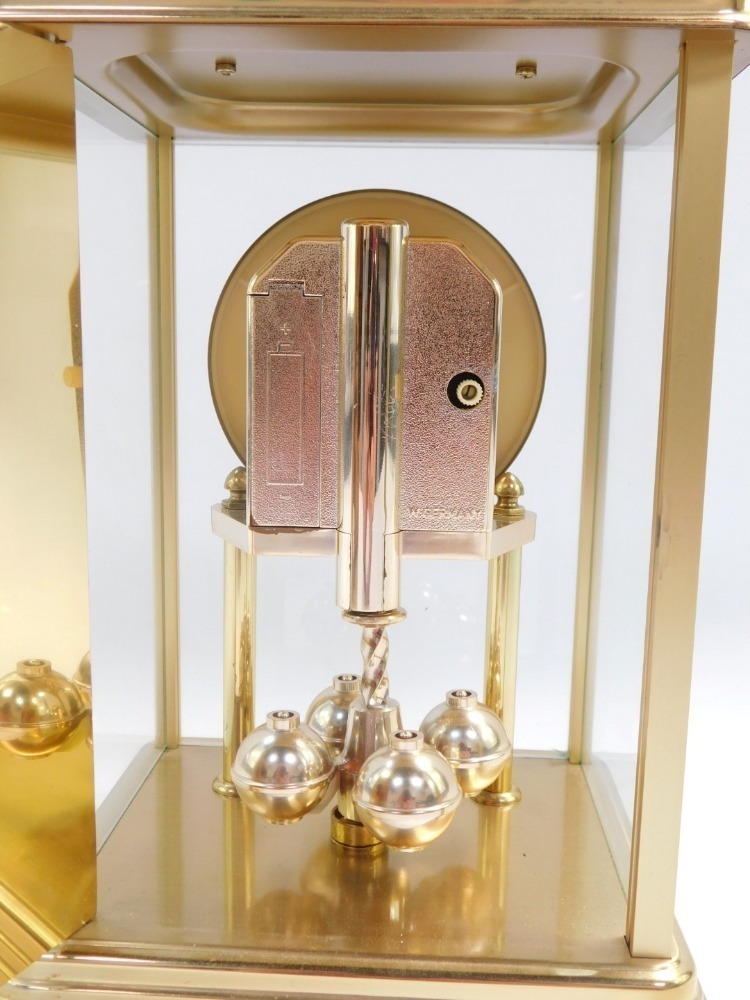 A Hermle brass cased Anniversary clock, the silvered dial with Roman ...