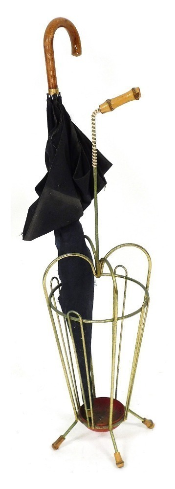 A mid century metal framed umbrella stand, of umbrella form, with a ...