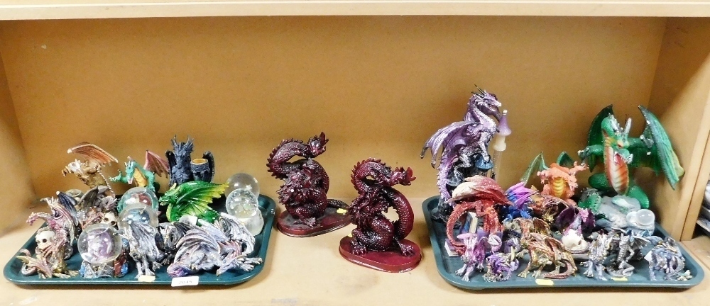 A group of resin models of dragons, in various poses and colour ways ...