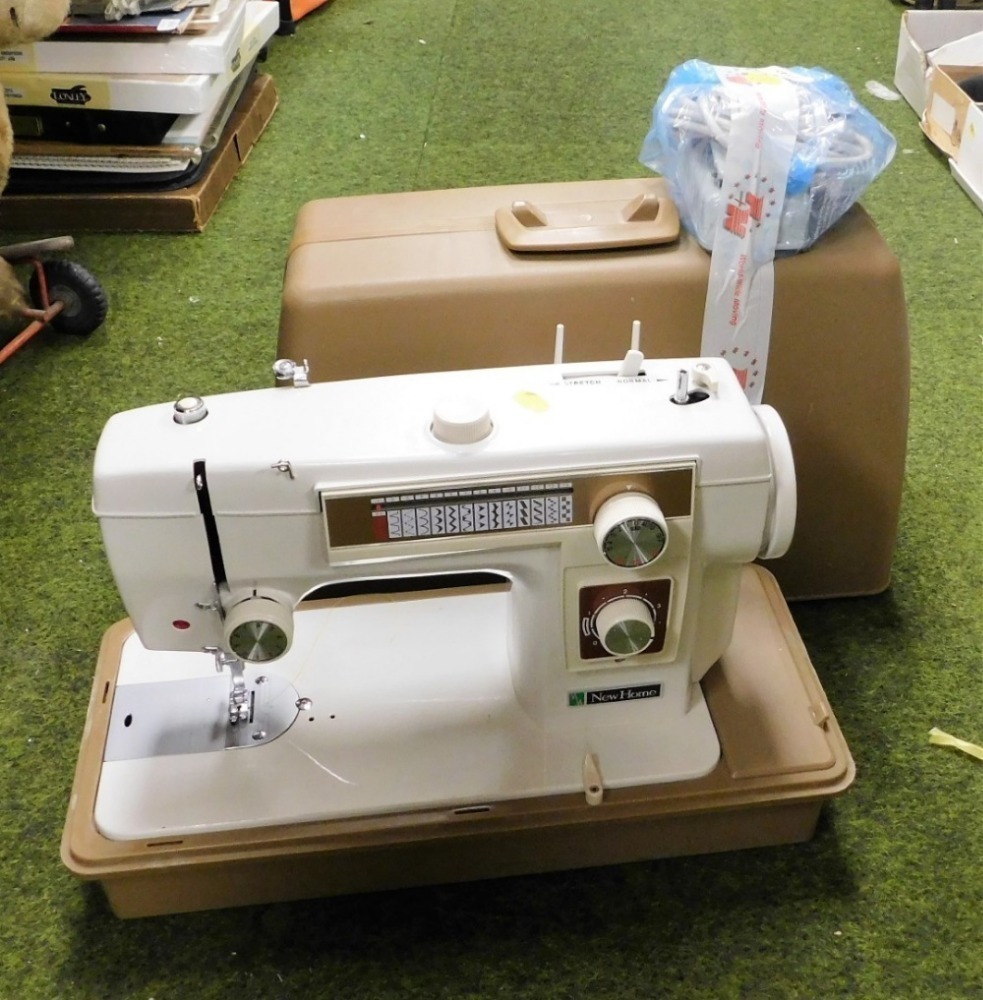 A cased New Home sewing machine. Buyer Note: WARNING! This lot contains ...