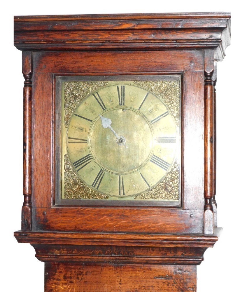 An 18thC country oak long case clock, with plain hood, small arched top ...