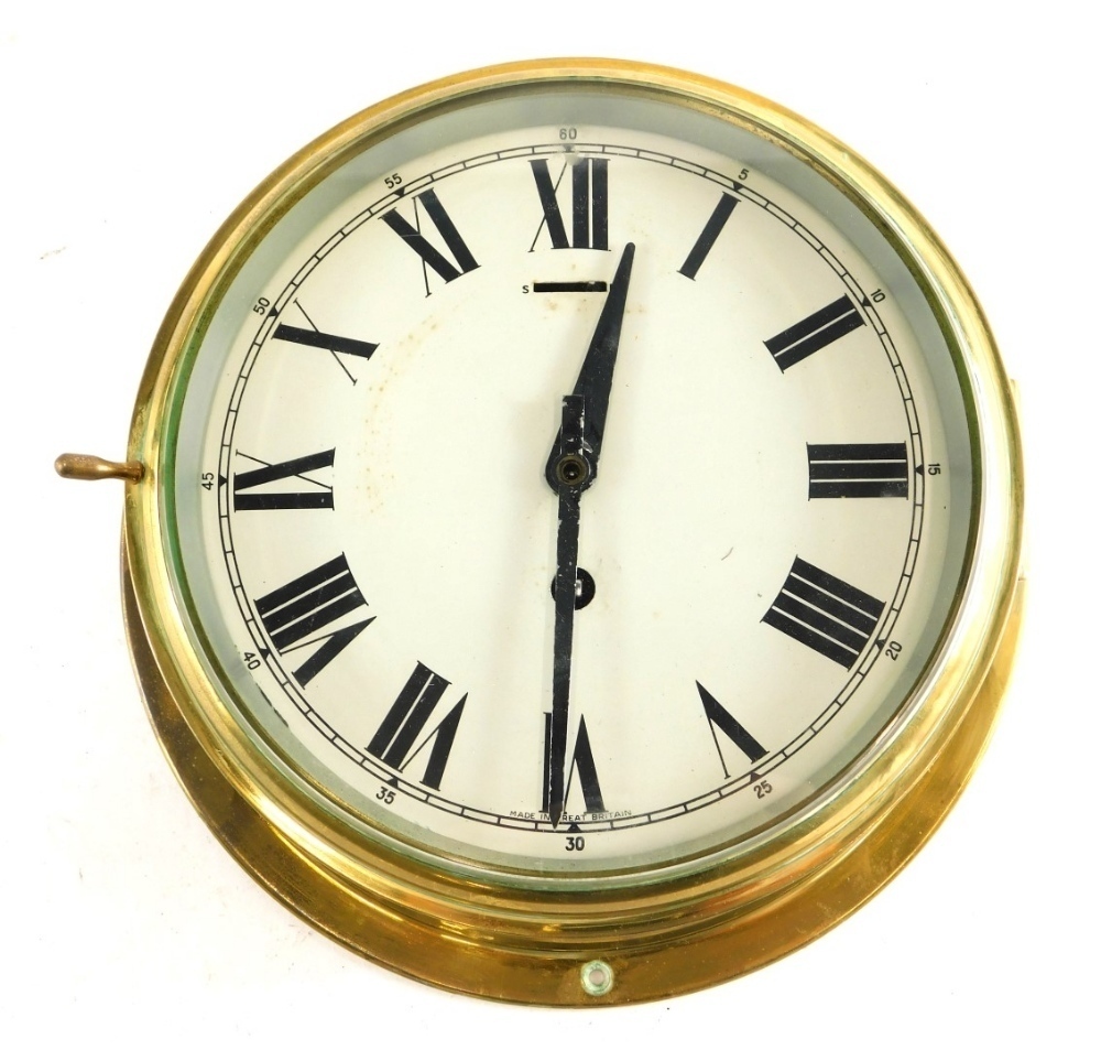 A 20thC brass bulkhead clock, of circular form, with 19cm diameter ...