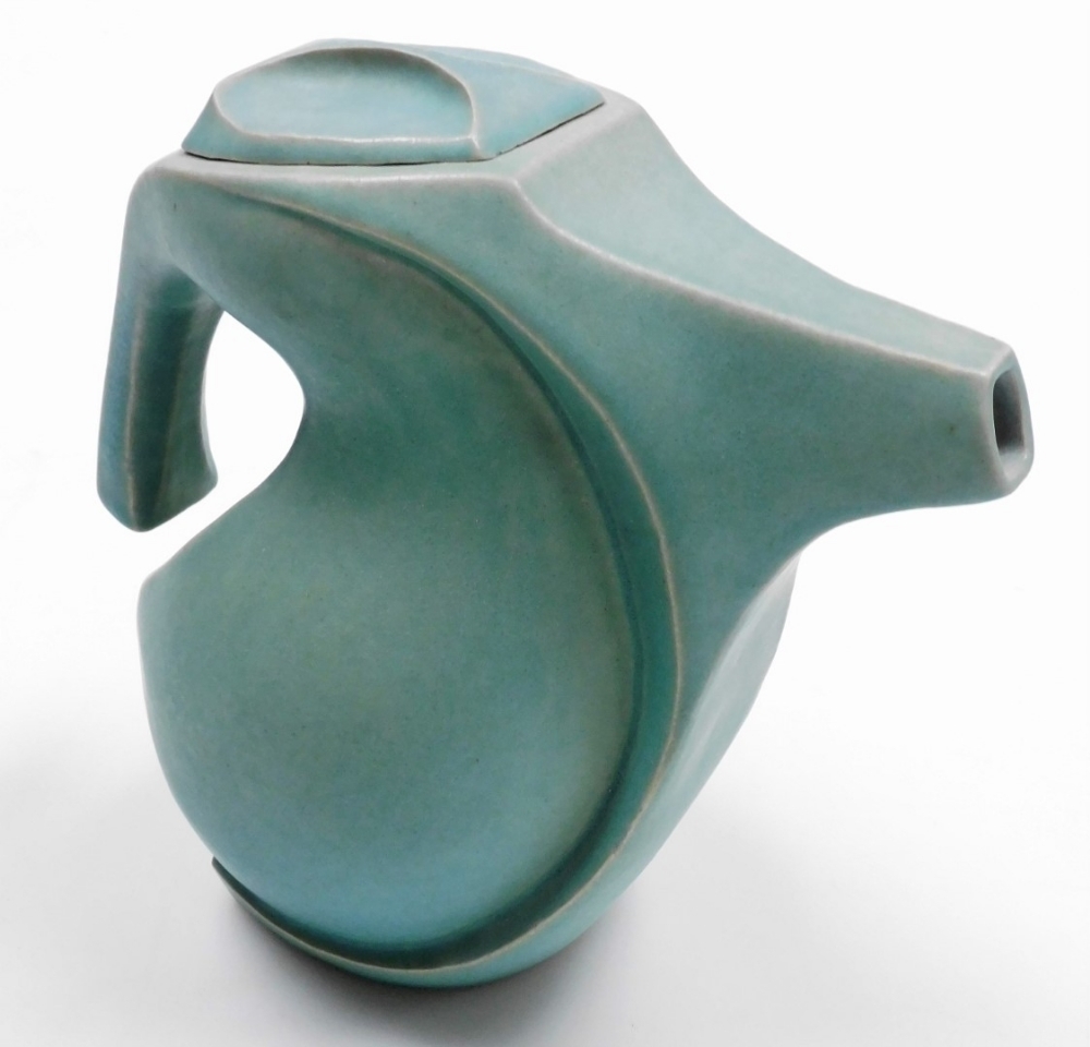 A studio pottery jug, of abstract form, matte turquoise glaze ...