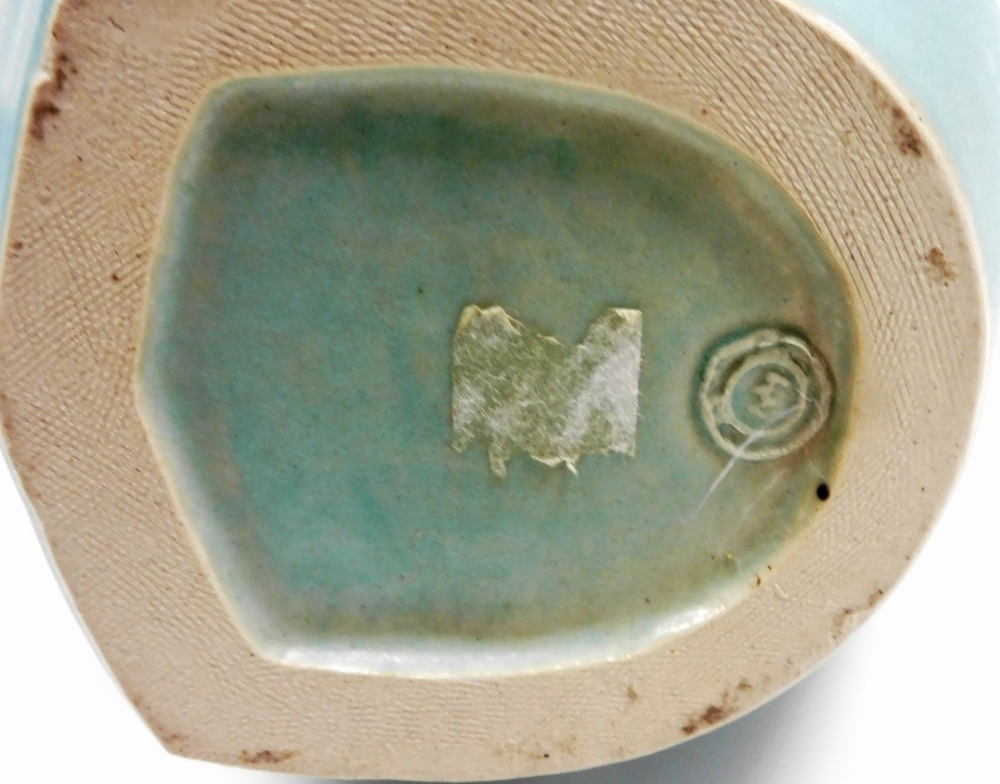 A studio pottery jug, of abstract form, matte turquoise glaze ...