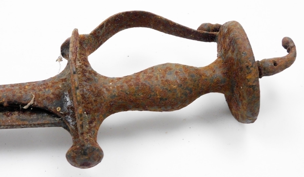 An Indian Talwar sabre, with an iron disc hilt and knuckle bow, 98cm long.