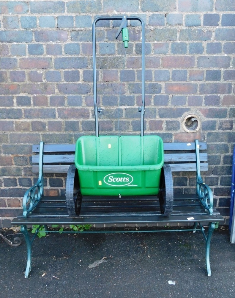 A garden bench with cast metal ends and a slatted back and seat, 122cm ...