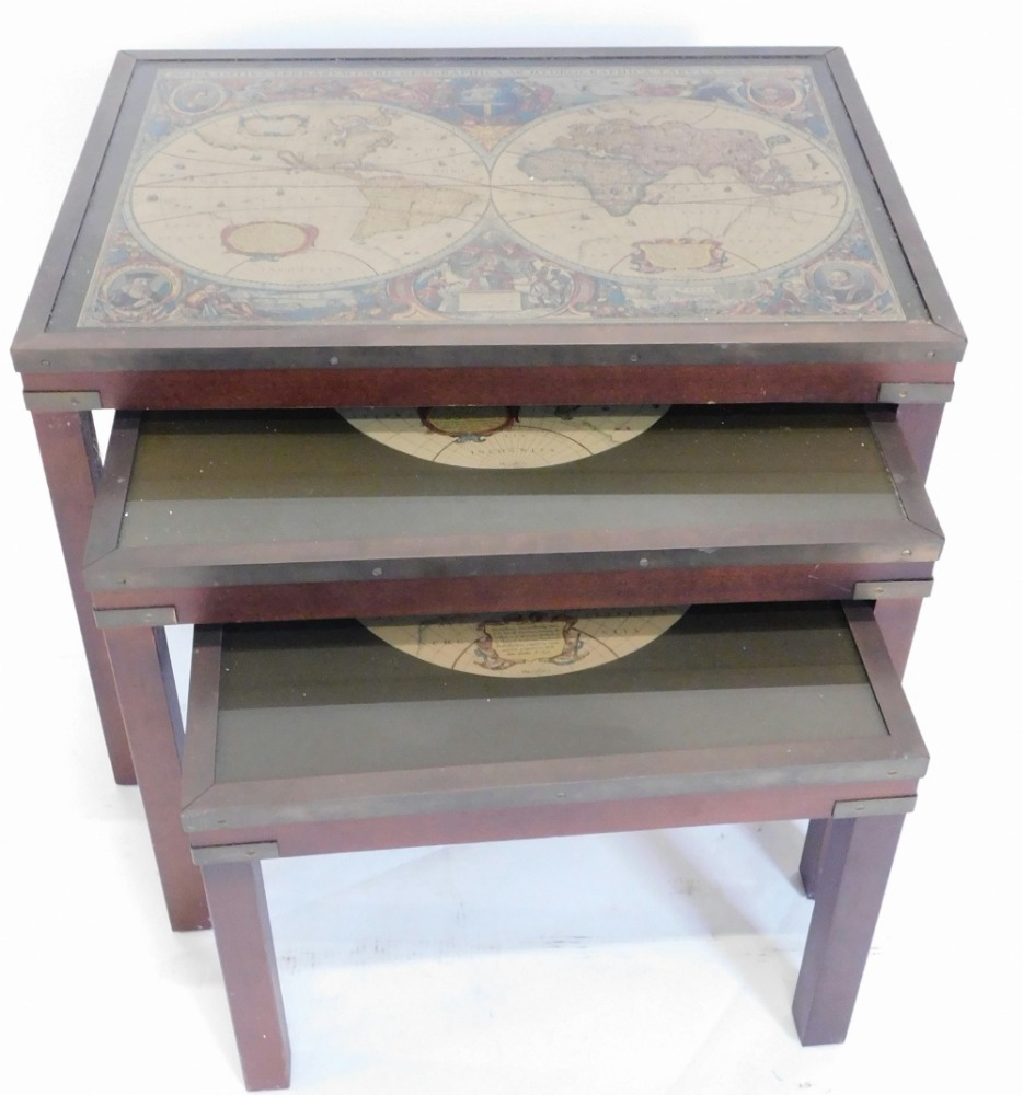A nest of three mahogany tables, each inset with a map of the world ...