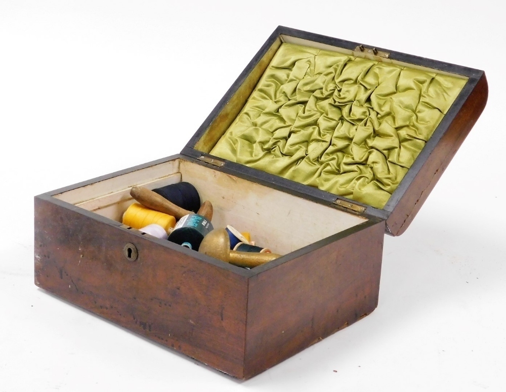 A Victorian walnut domed sewing box, containing sewing accoutrements ...