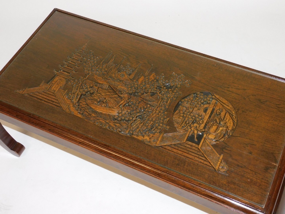 A Chinese hardwood coffee table, of rectangular altar form, the top ...