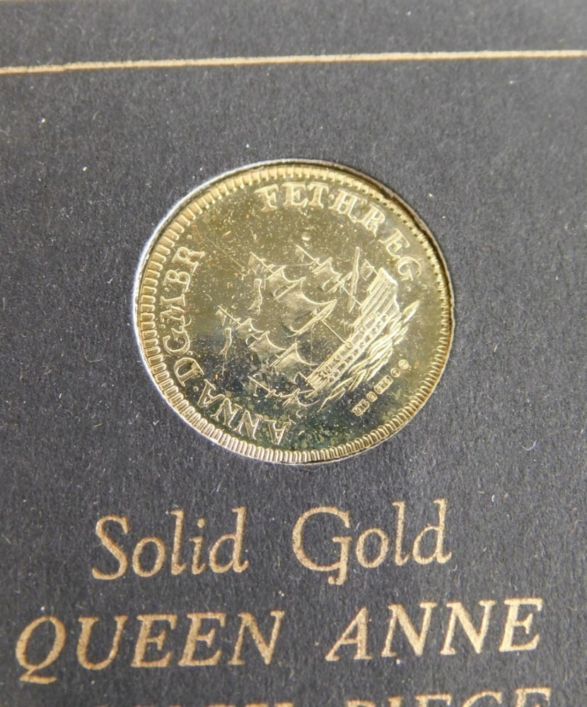 A gold Queen Anne touch piece type coin, cased, with ship and full sail ...