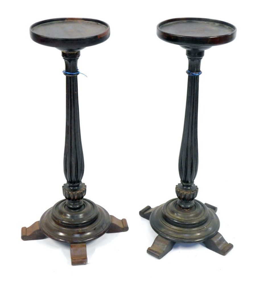 A pair of mahogany plant stands, circular foot on a reeded and bulbous ...